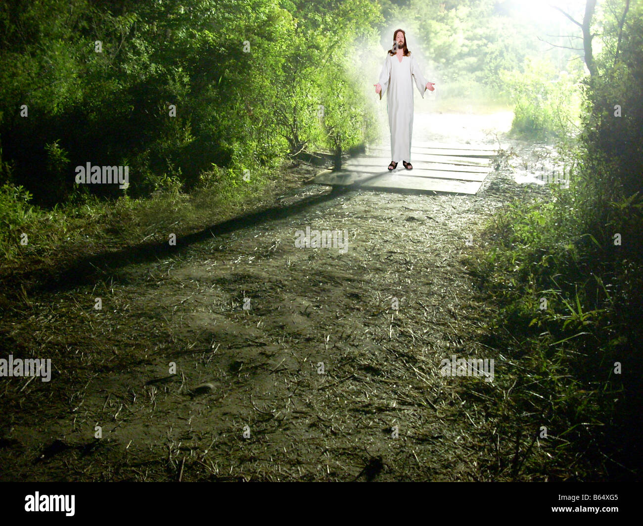 Jesus creating a long shadow on a path in the woods Stock Photo - Alamy