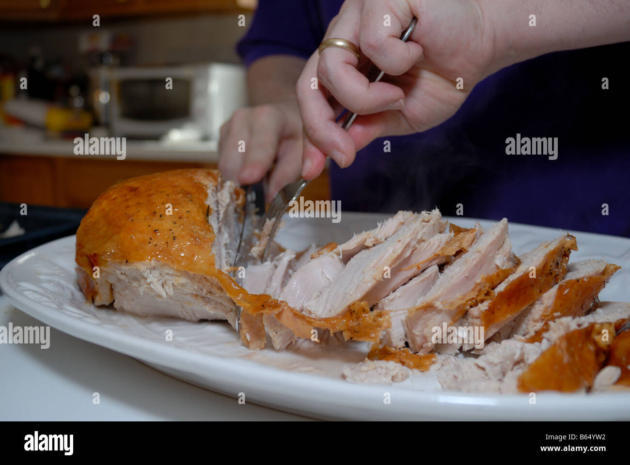 A man slices turkey on Thanksgiving day Stock Photo - Alamy