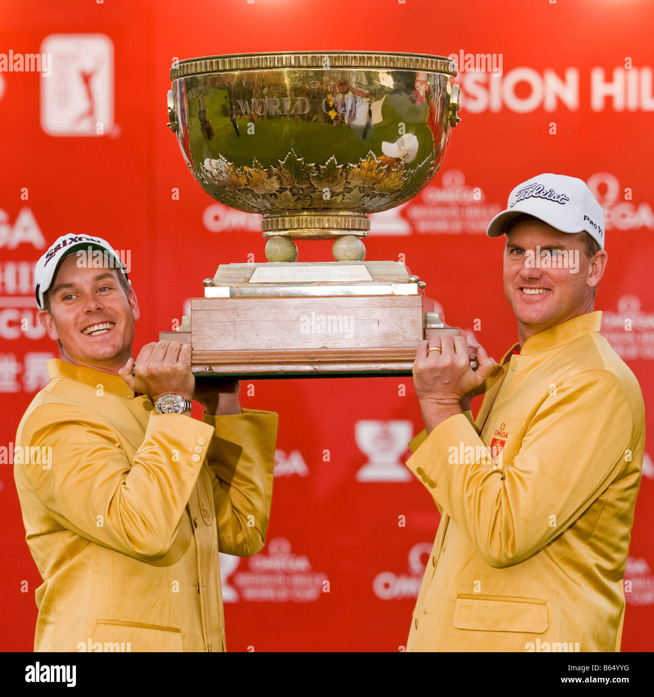 Henrik Stenson and Robert Karlsson of Sweden pose with the trophy after ...