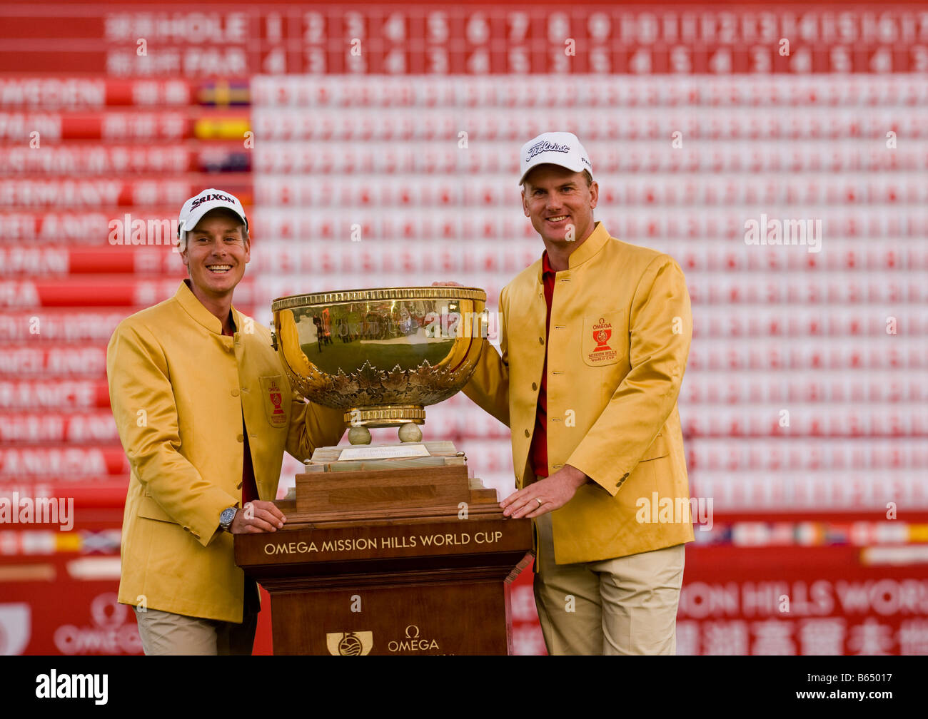 Henrik Stenson and Robert Karlsson of Sweden pose with the trophy after ...