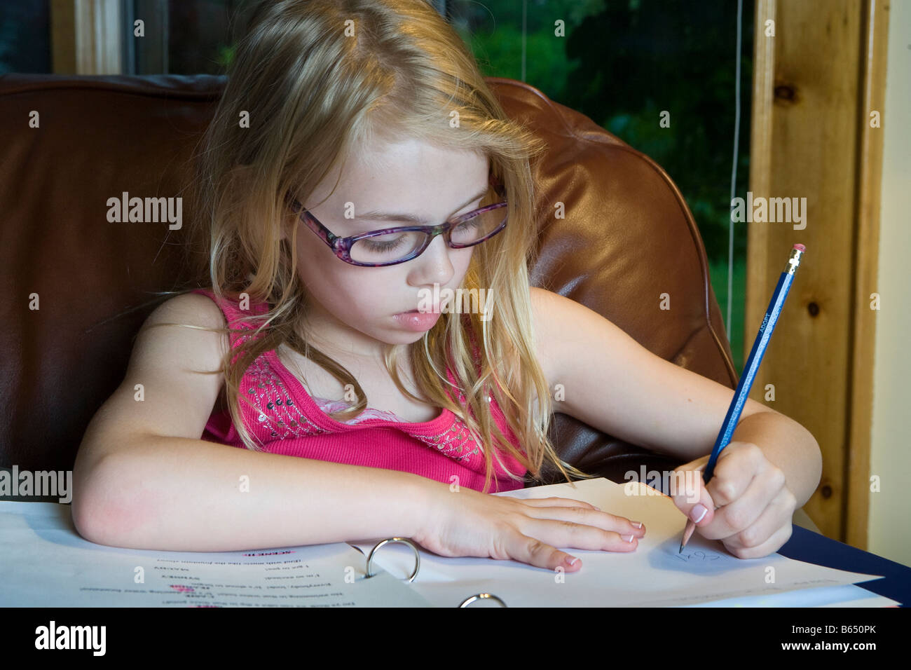 Child writing in a notebook Stock Photo - Alamy