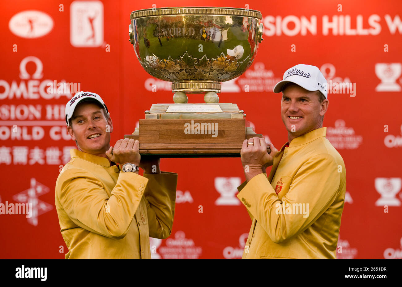 Henrik Stenson and Robert Karlsson of Sweden pose with the trophy after ...