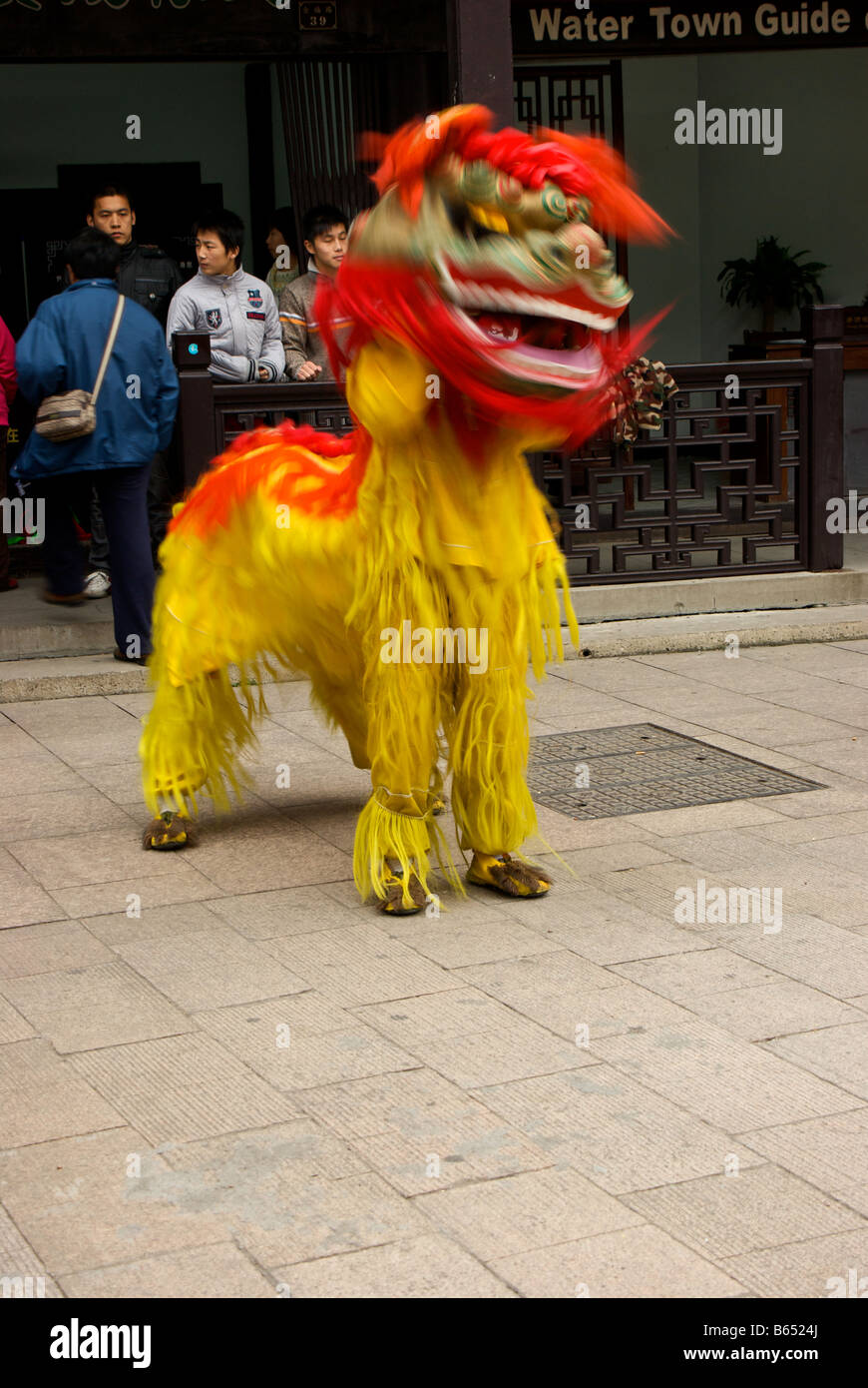 Lion dance performance with red head in frantic motion blur at Water ...