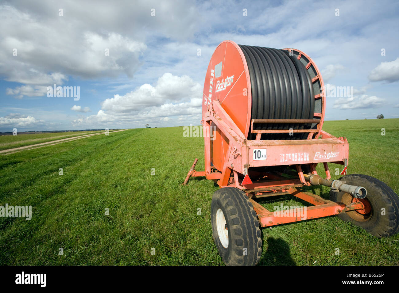 agricultural farming irrigation hose on a large reel at rural Stenigot ...