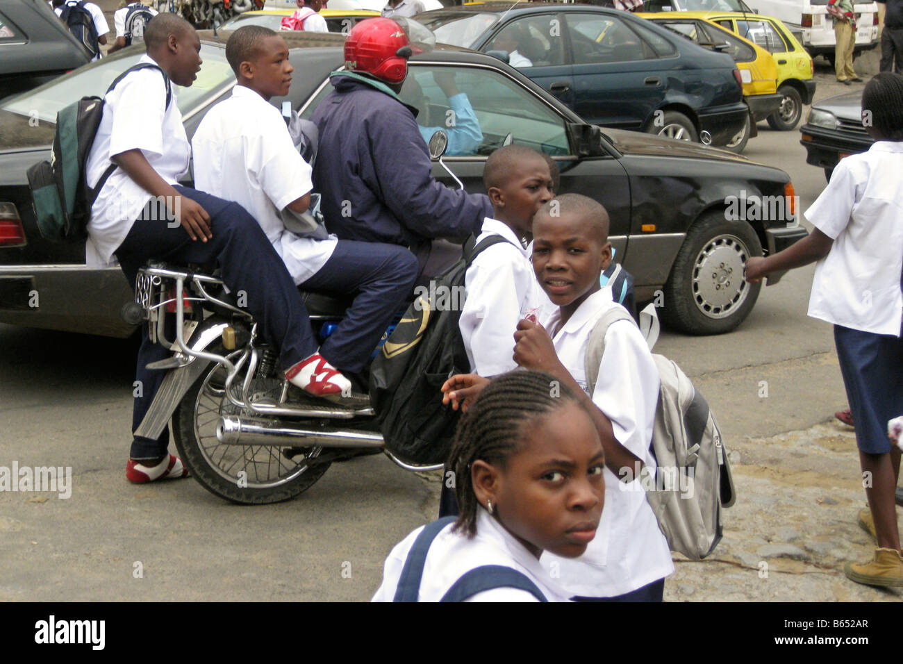 Schoolchildren and motorcycle taxi, Douala Cameroon Africa Stock Photo ...