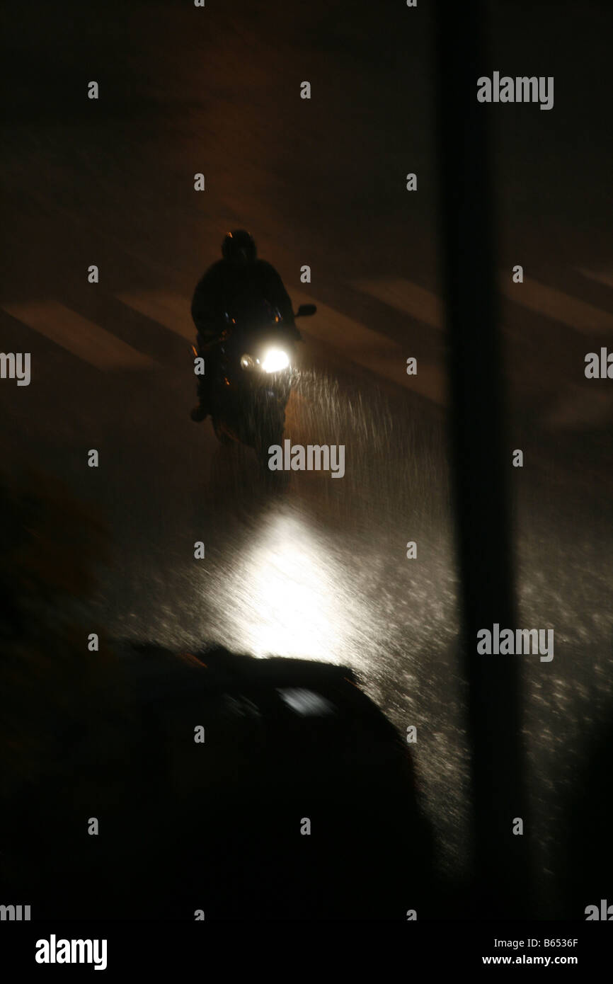 fast motorbike rider heavy rain at night in town Stock Photo - Alamy