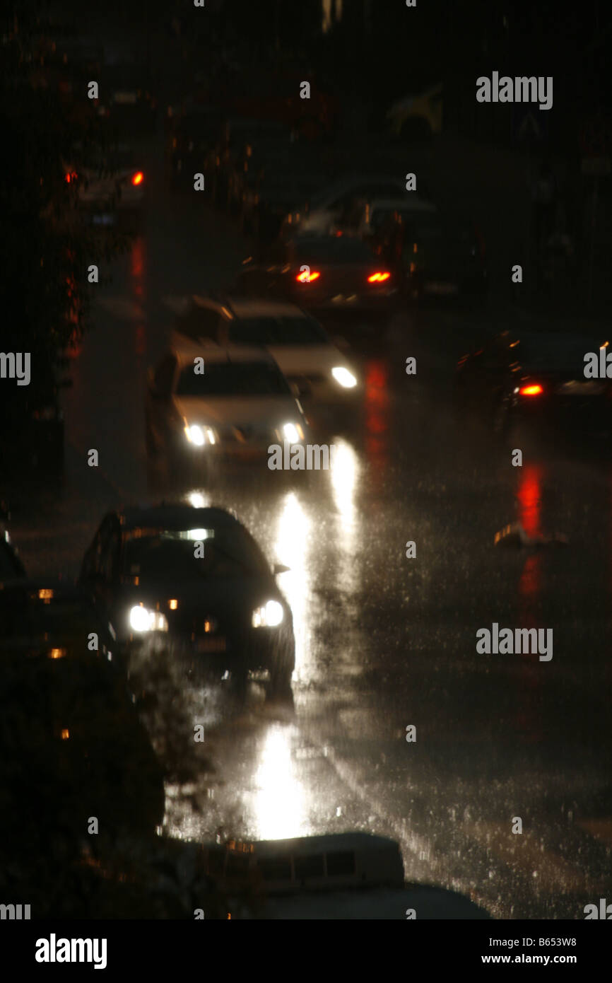 fast cars driving in heavy rain at night in town Stock Photo - Alamy