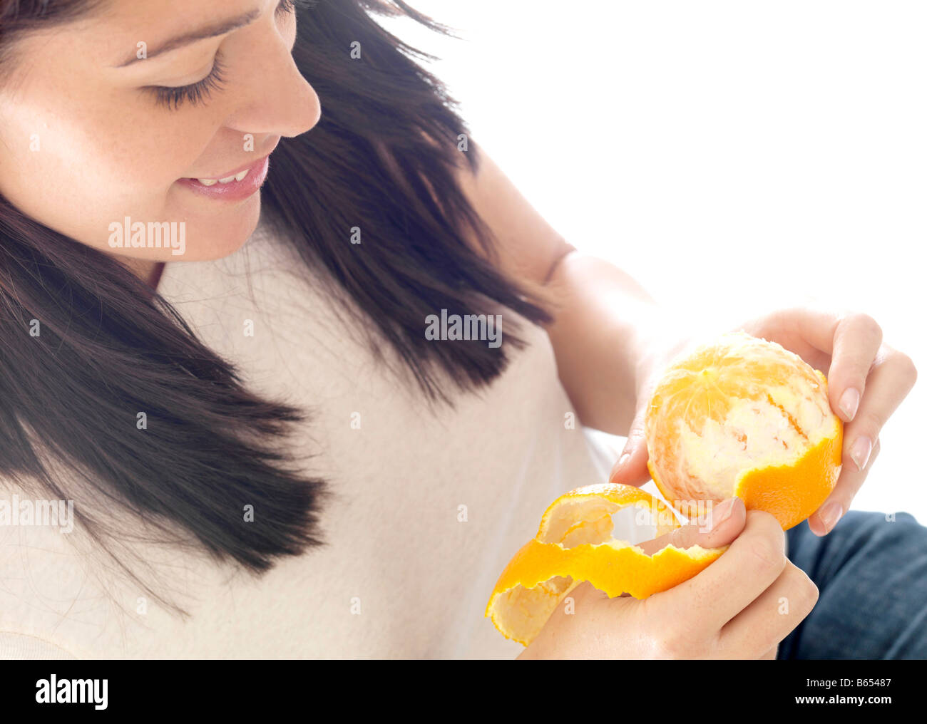 Woman Peeling An Orange Model Released Stock Photo - Alamy