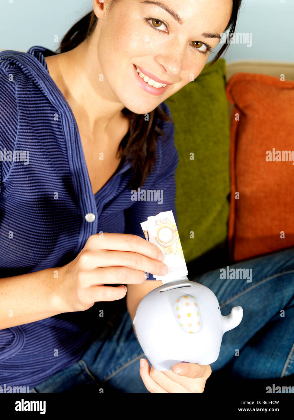 Young Woman Saving Money Model Released Stock Photo - Alamy