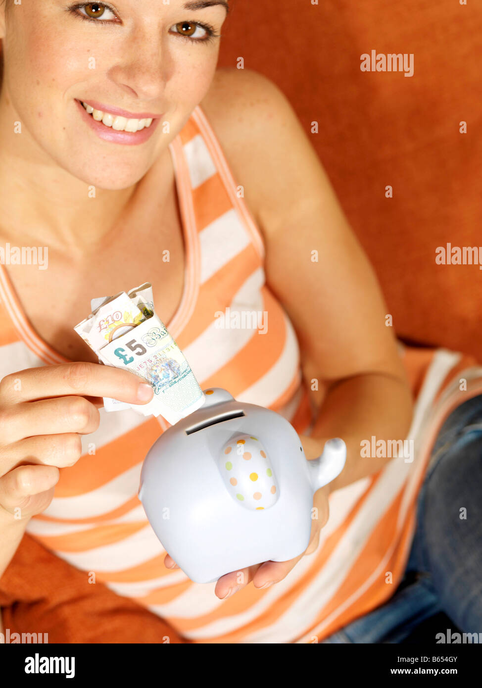 Young Woman Saving Money Model Released Stock Photo - Alamy