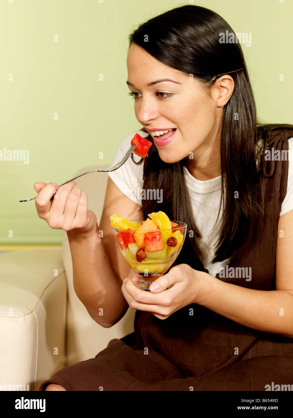 Young Woman Eating Fruit Salad Model Released Stock Photo - Alamy