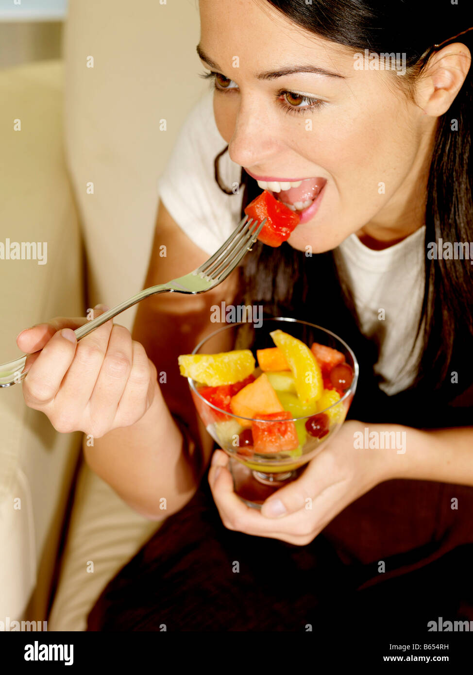 Young Woman Eating Fruit Salad Model Released Stock Photo - Alamy