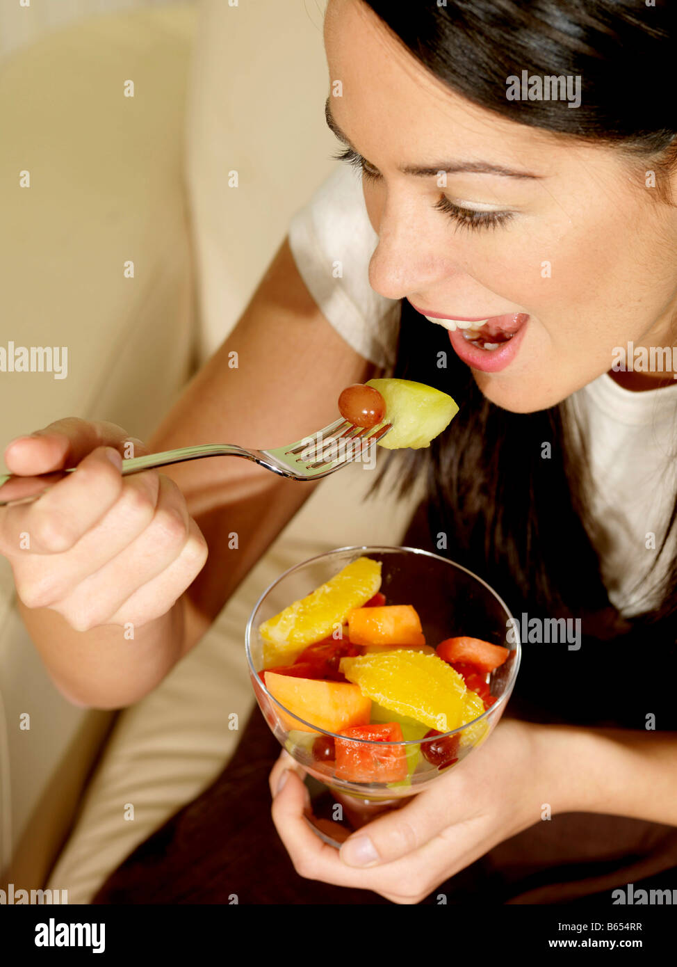 Young Woman Eating Fruit Salad Model Released Stock Photo - Alamy