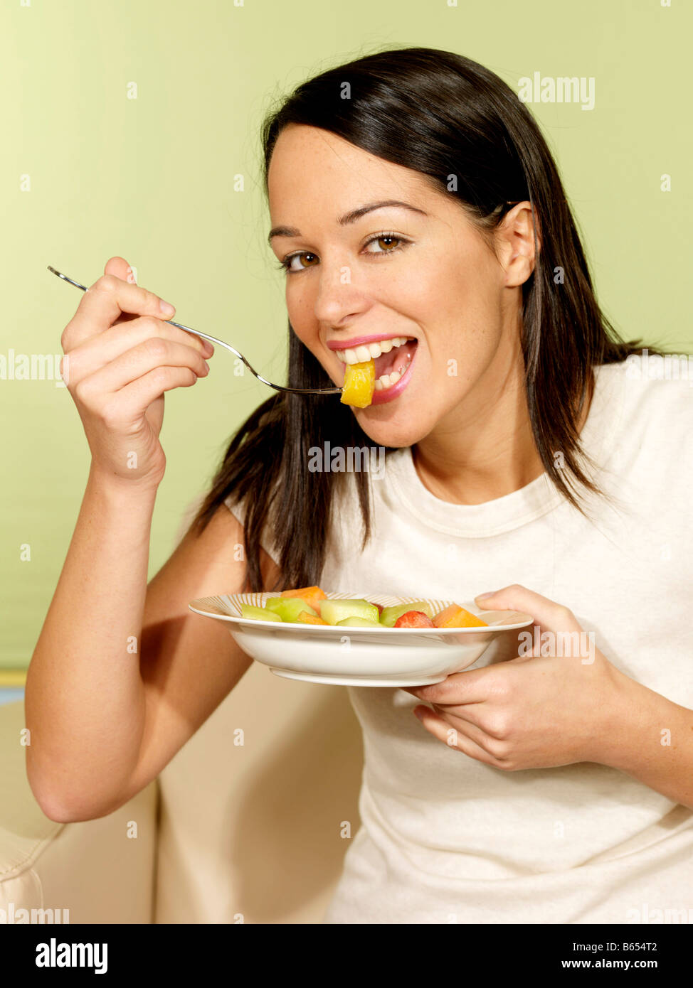 Young Woman Eating Fruit Salad Model Released Stock Photo - Alamy