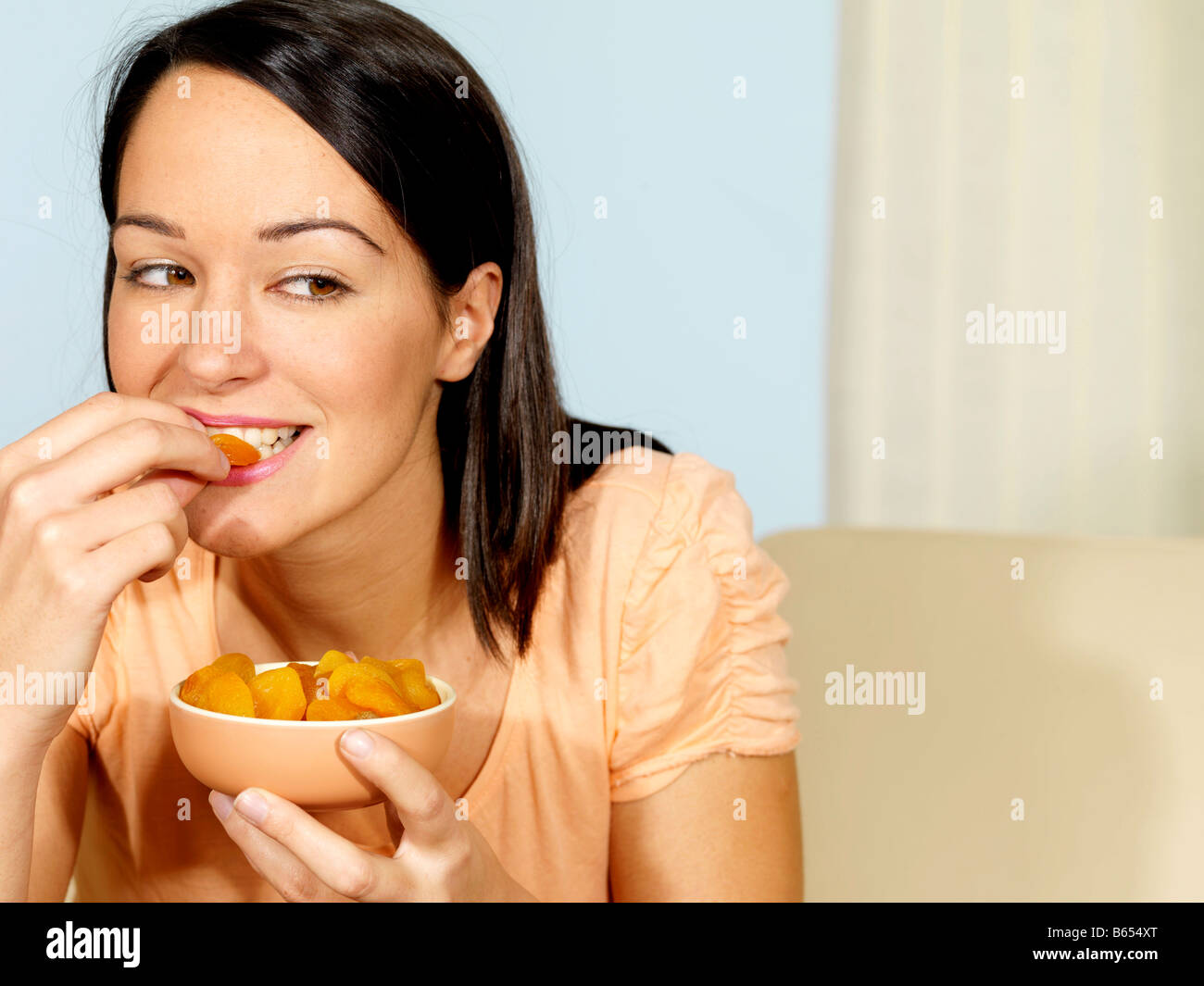 Young Woman Eating Dried Fruit Model Released Stock Photo - Alamy
