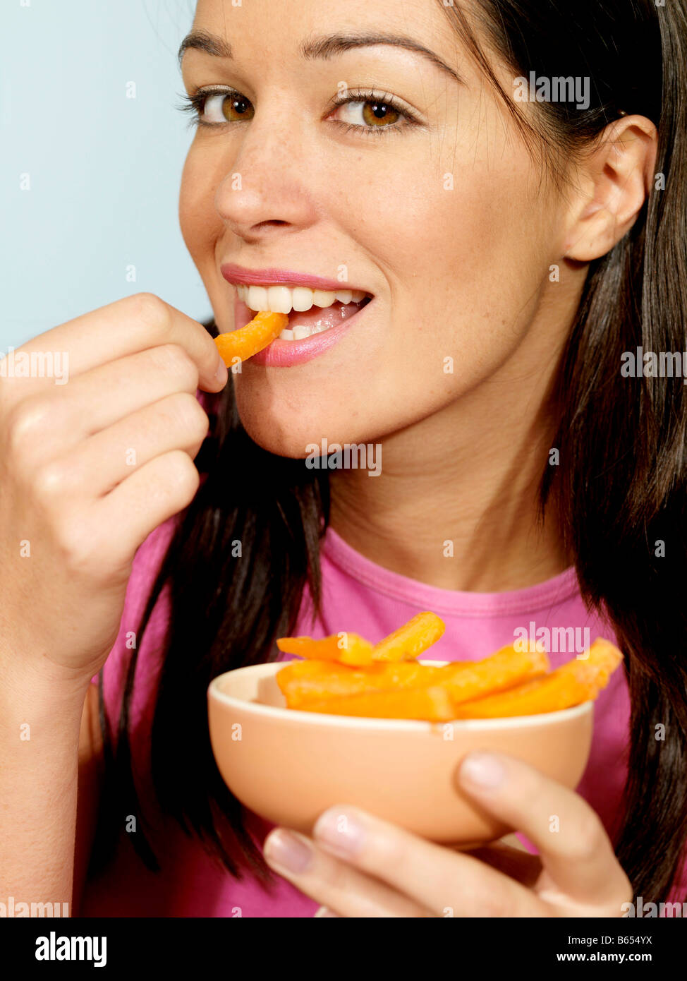 Young Woman Eating Carrot Sticks Model Released Stock Photo - Alamy