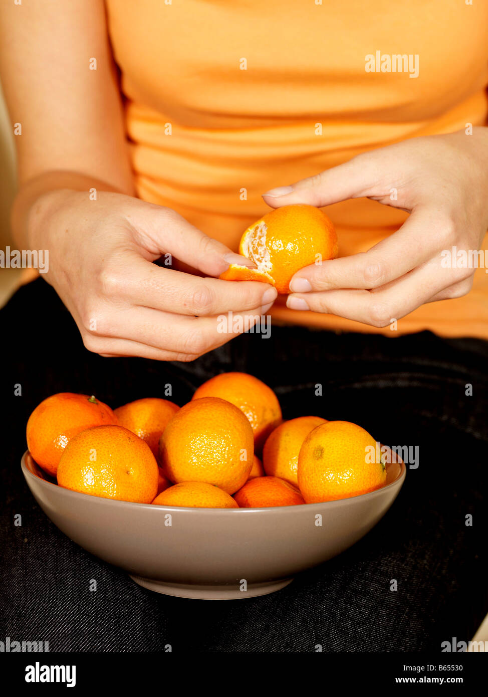 Young Woman Eating an Orange Model Released Stock Photo - Alamy