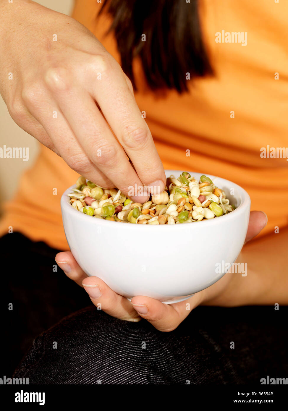 Young Woman Eating Mixed Beans Model Released Stock Photo - Alamy