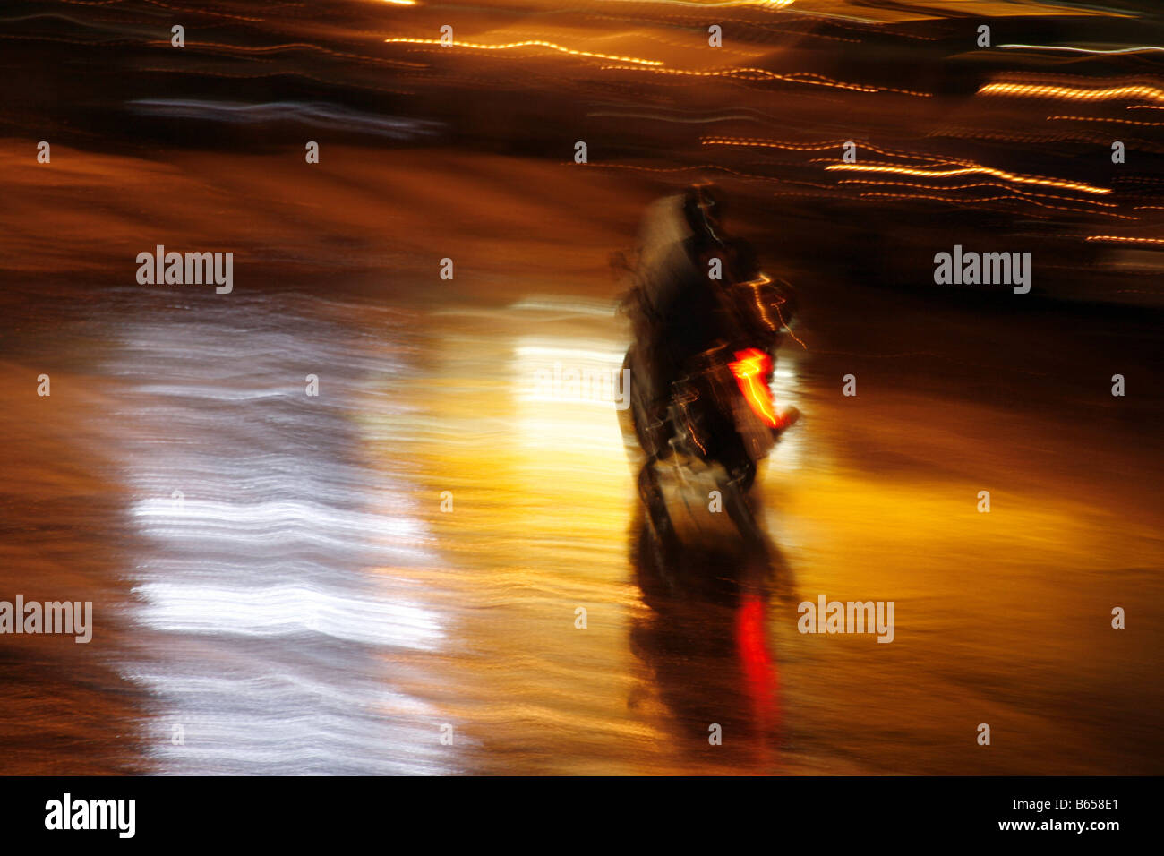 fast motorbike rider heavy rain at night in town Stock Photo - Alamy