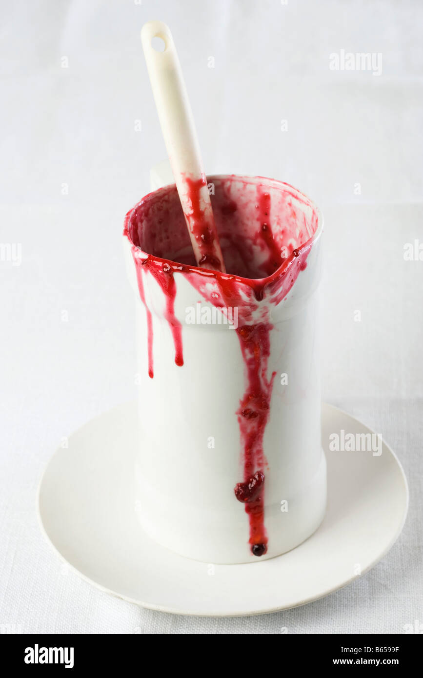 Messy pitcher of strawberry syrup Stock Photo - Alamy