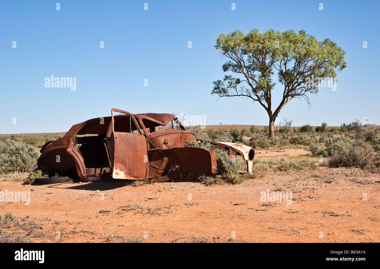 great image of an old car rusting away in the desert Stock Photo - Alamy