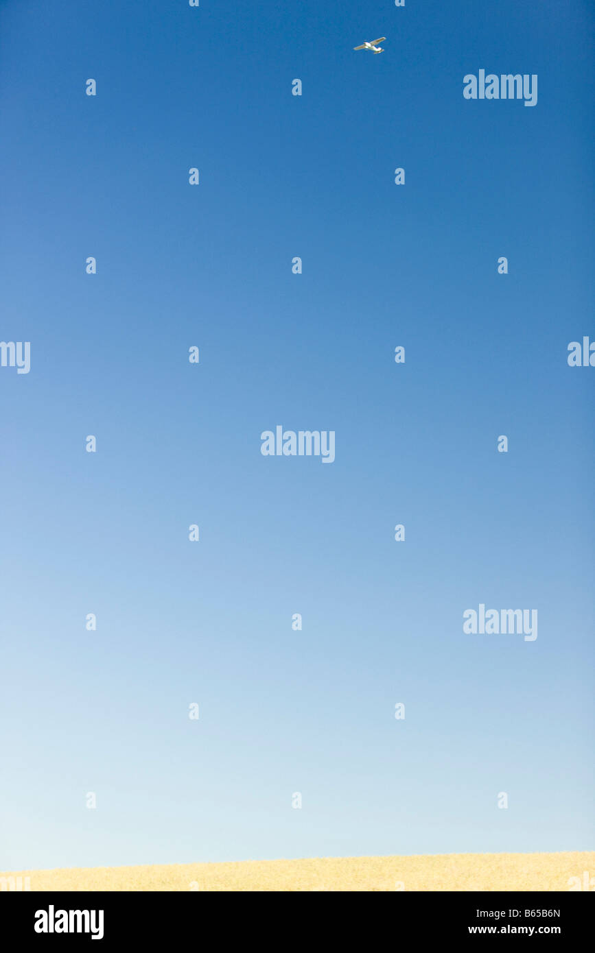 Clear blue sky, plane high in the distance Stock Photo - Alamy