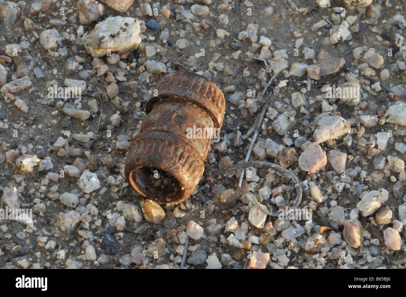 Rusty old electrical coupling on a bed of rocks Stock Photo - Alamy