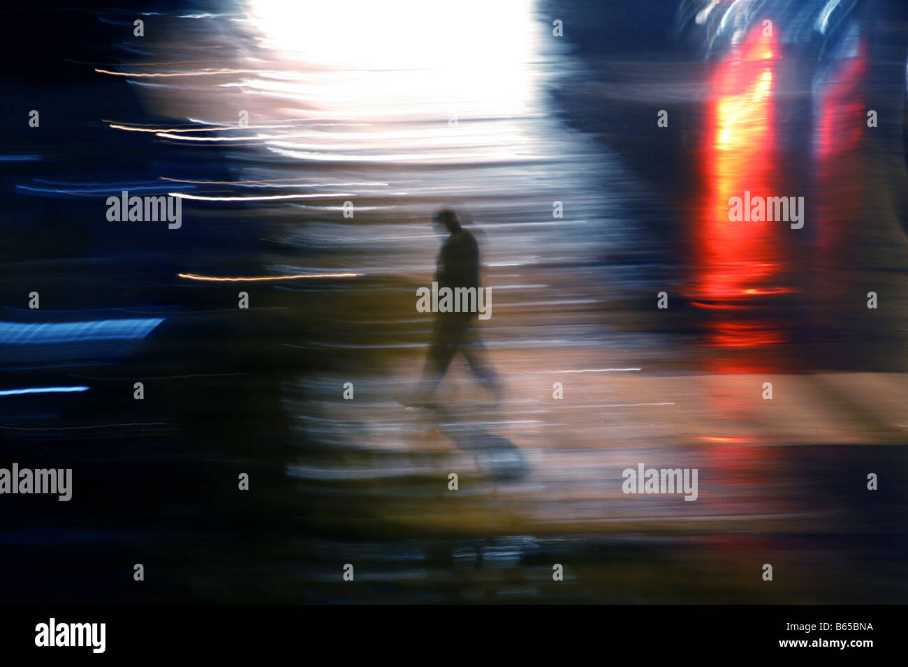 person walking in heavy rain at night in town Stock Photo - Alamy