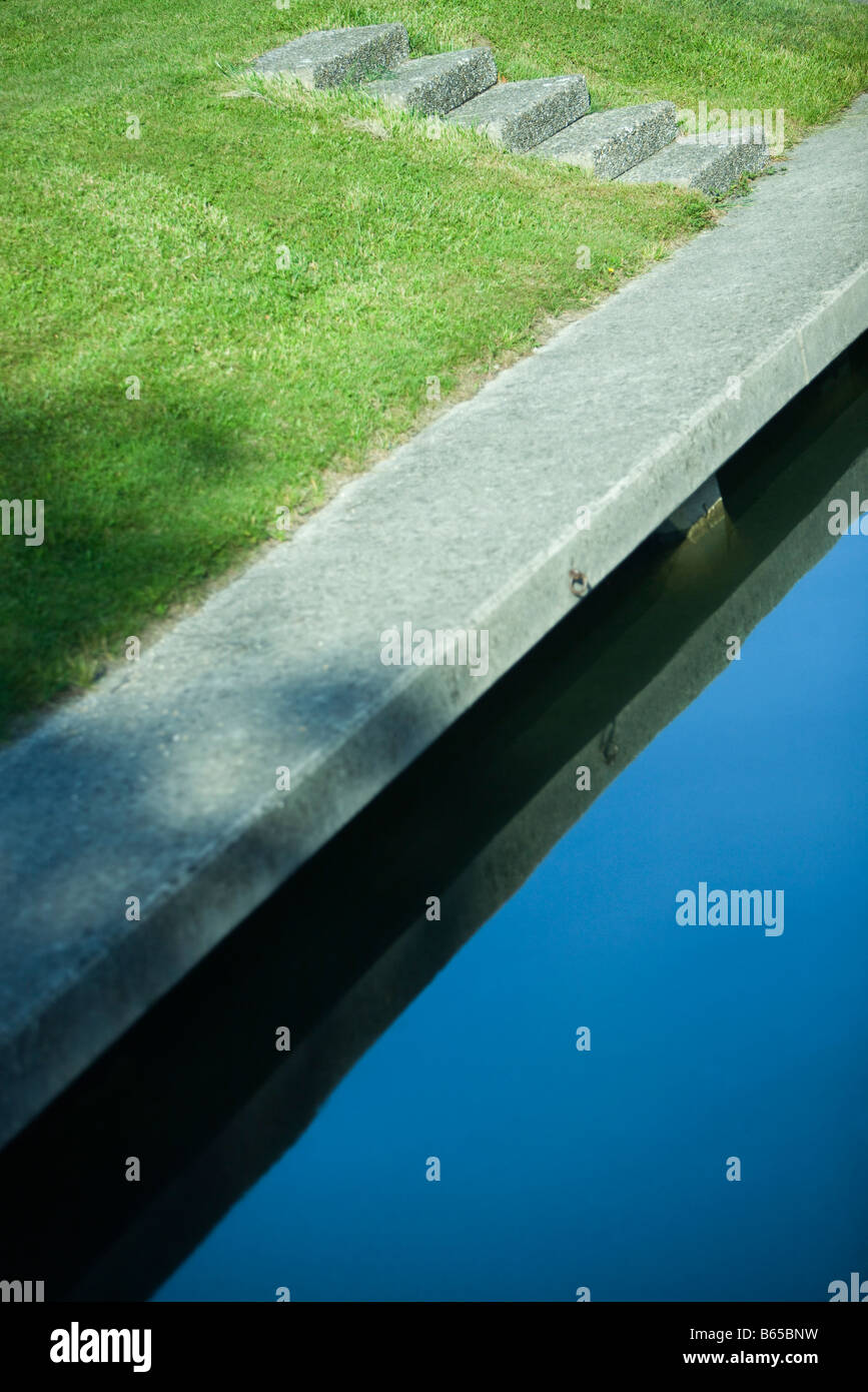Stone path and steps on embankment beside water Stock Photo - Alamy