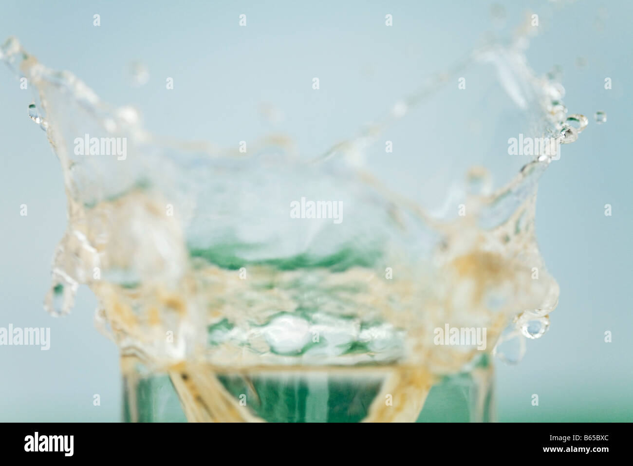 Water splashing out of glass Stock Photo - Alamy