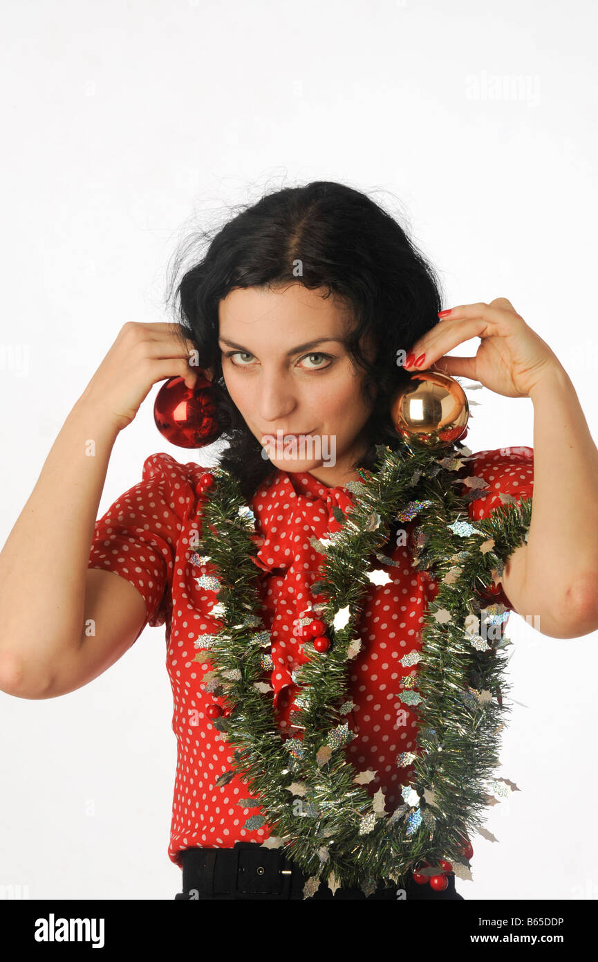 Woman with dark hair and red top wrapped in Christmas tinsel and ...