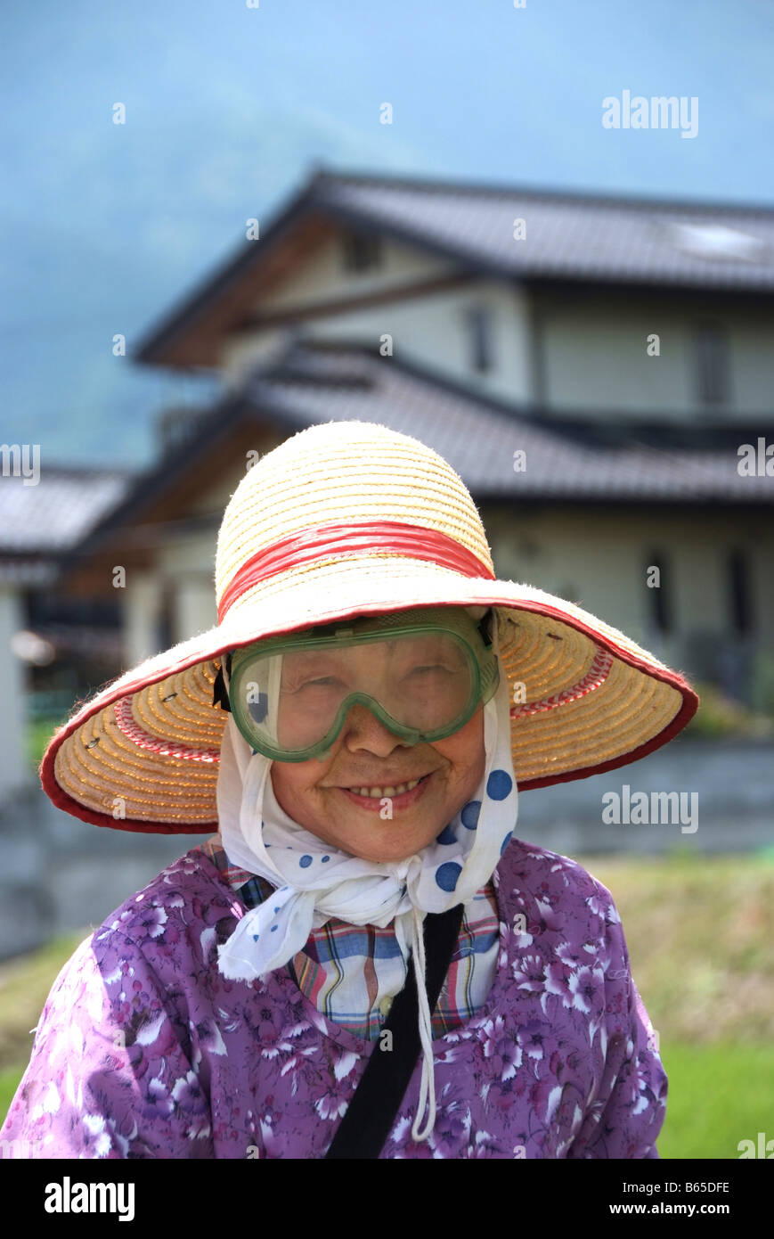 Portrait of an old lady with goggles cutting grass Stock Photo - Alamy