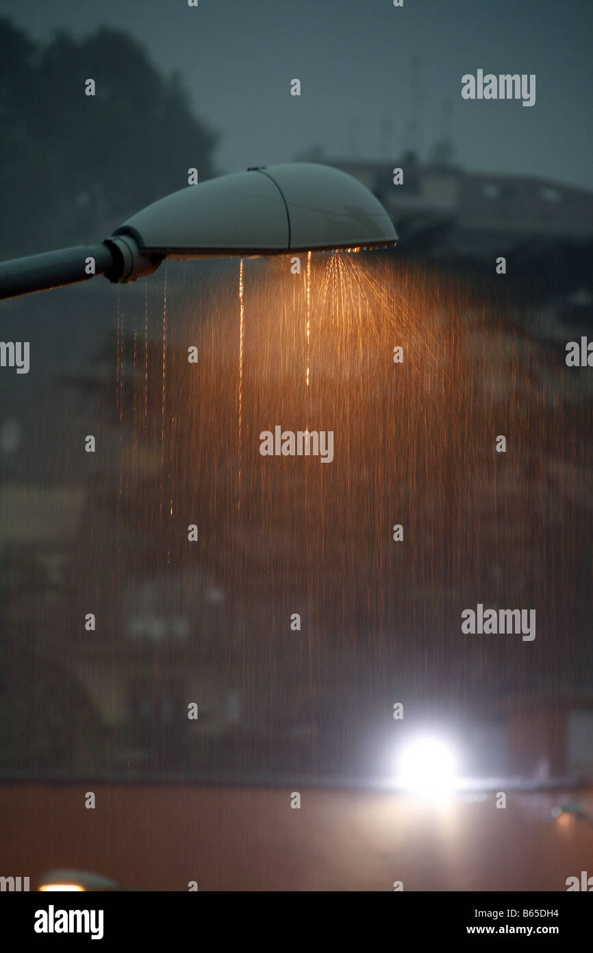 one street lamp in heavy rain at night city town Stock Photo - Alamy