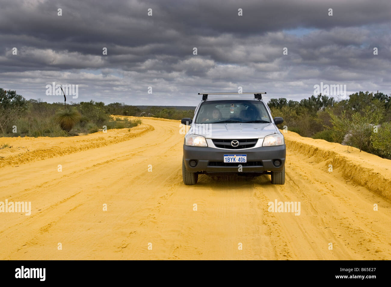 A 4wd driving down a sandy unsealed road in Kalbarri National Park ...