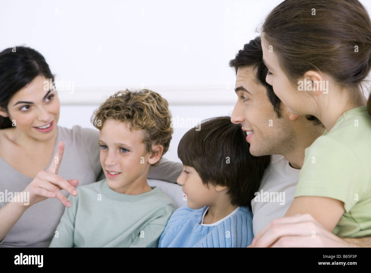 Family sitting together, having a discussion Stock Photo - Alamy