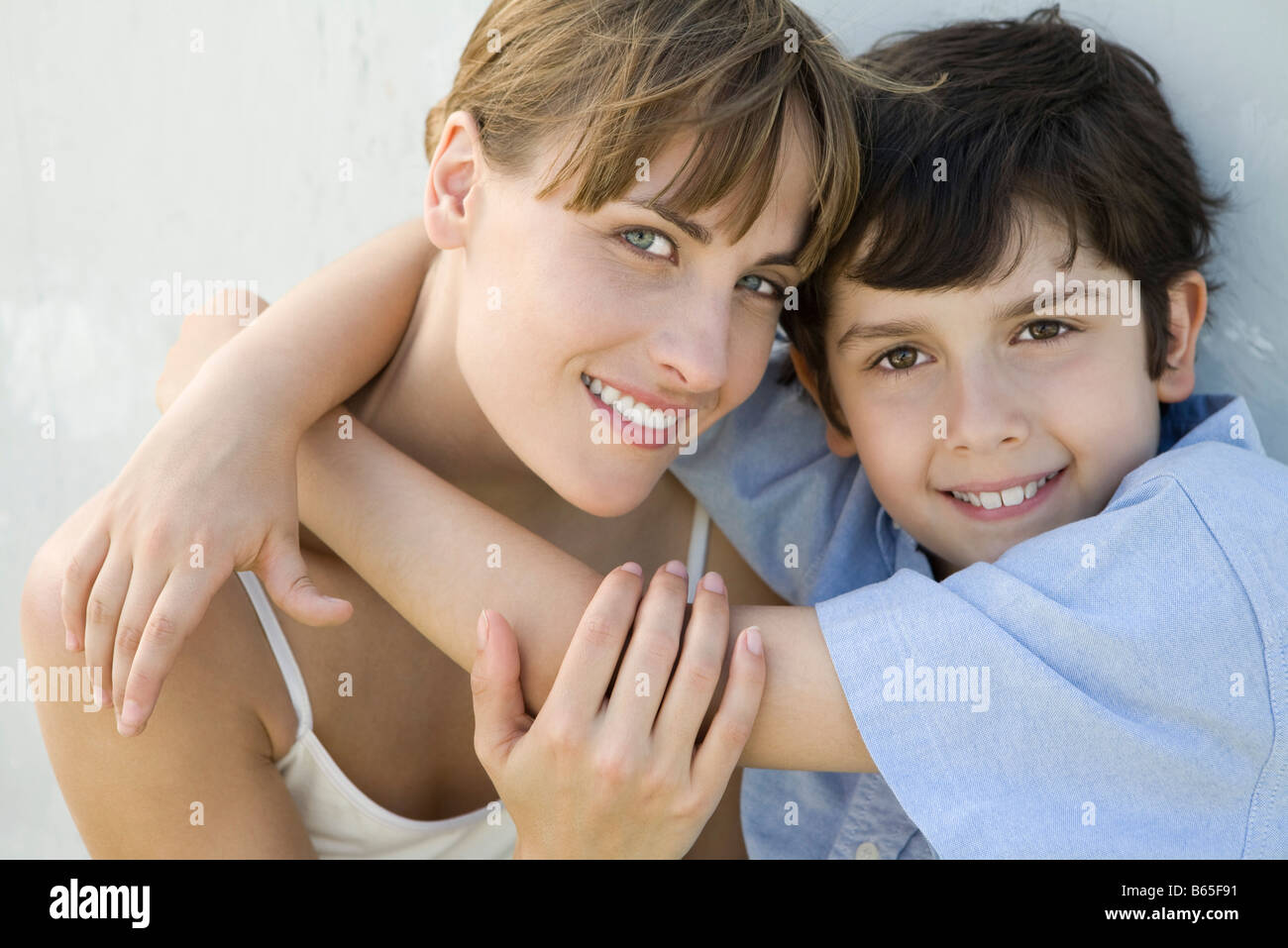 Mother and son embracing, both smiling at camera Stock Photo - Alamy