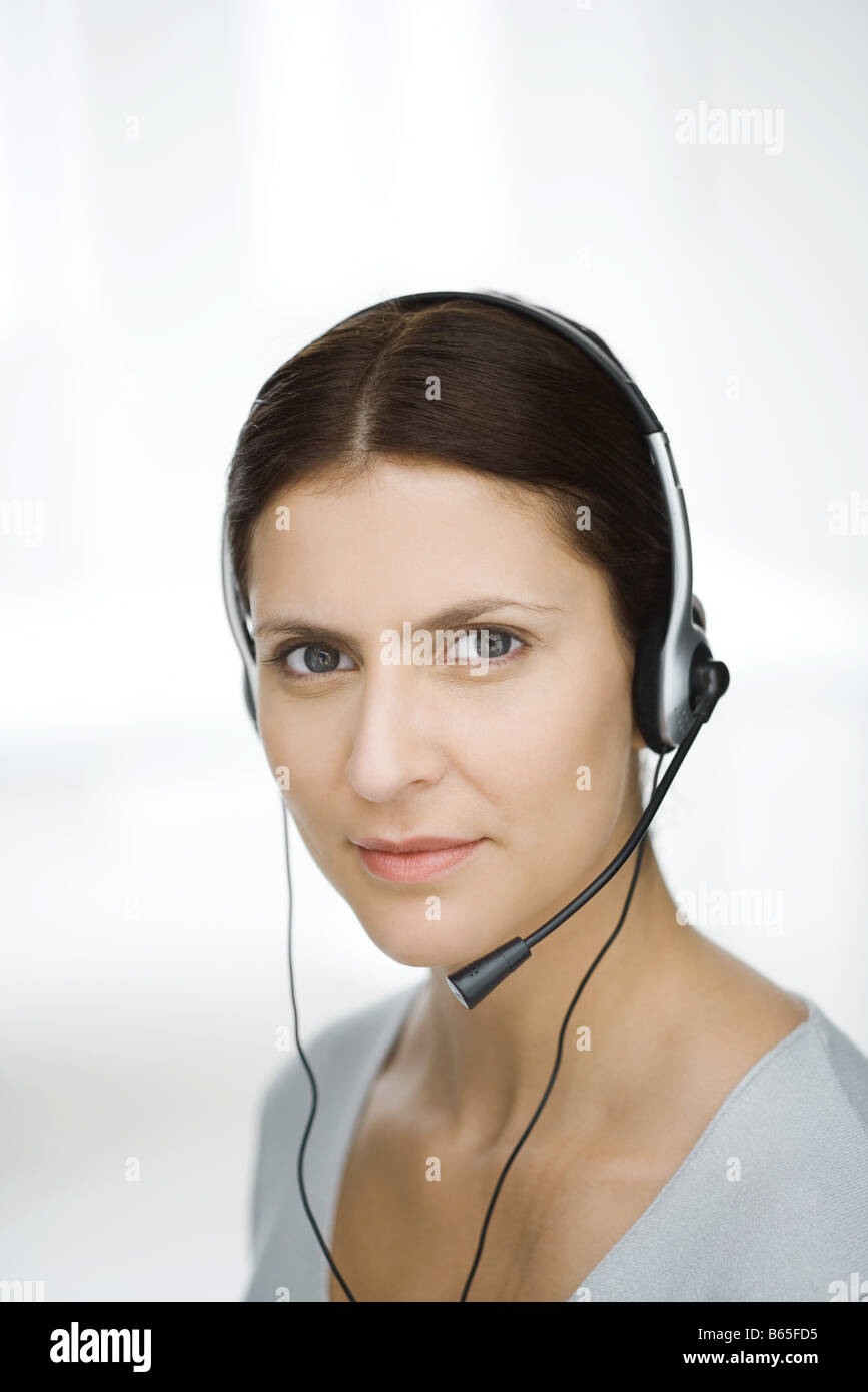 Woman wearing headset, looking at camera, portrait Stock Photo - Alamy