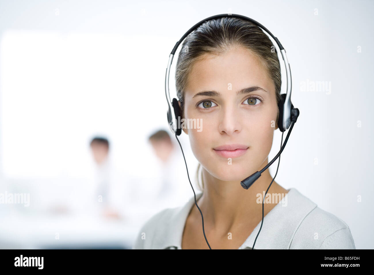 Woman wearing headset, looking at camera, portrait Stock Photo - Alamy