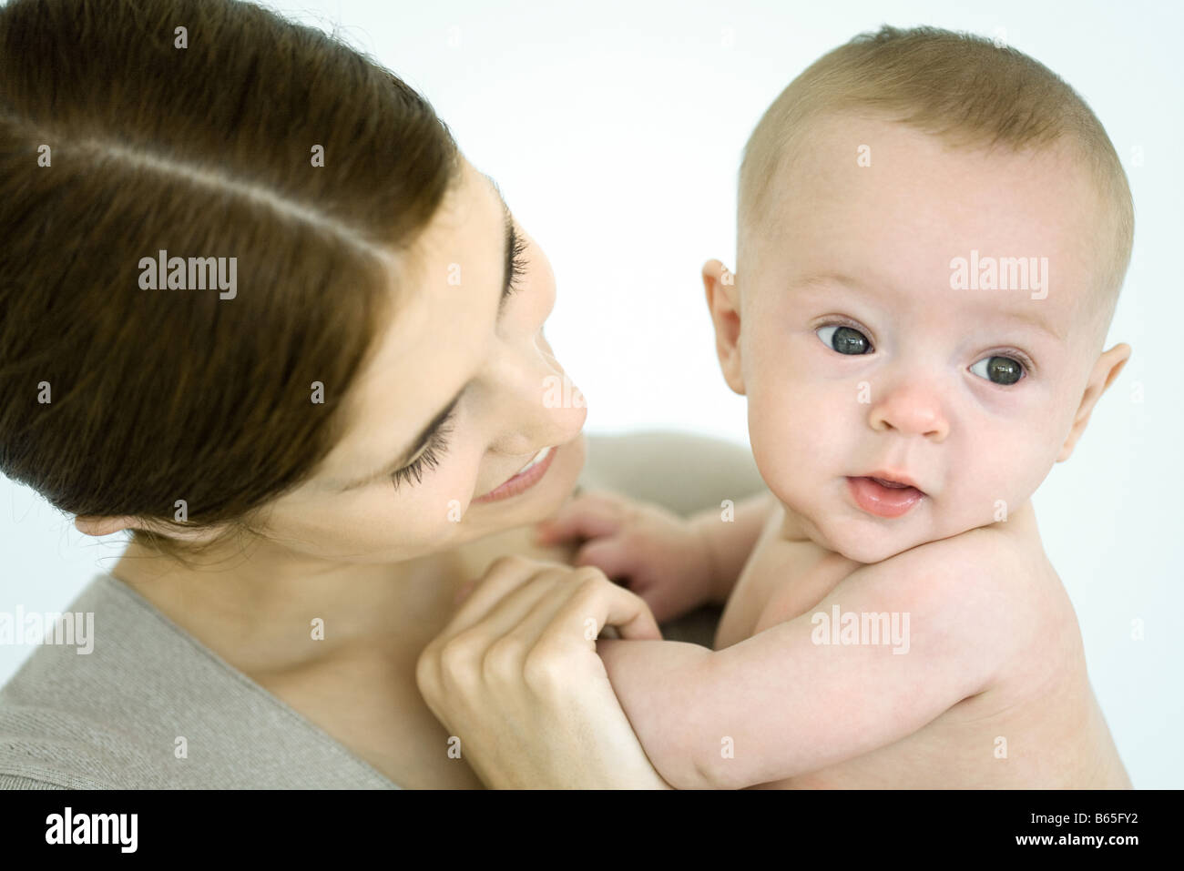 Mother holding infant, baby looking away Stock Photo - Alamy