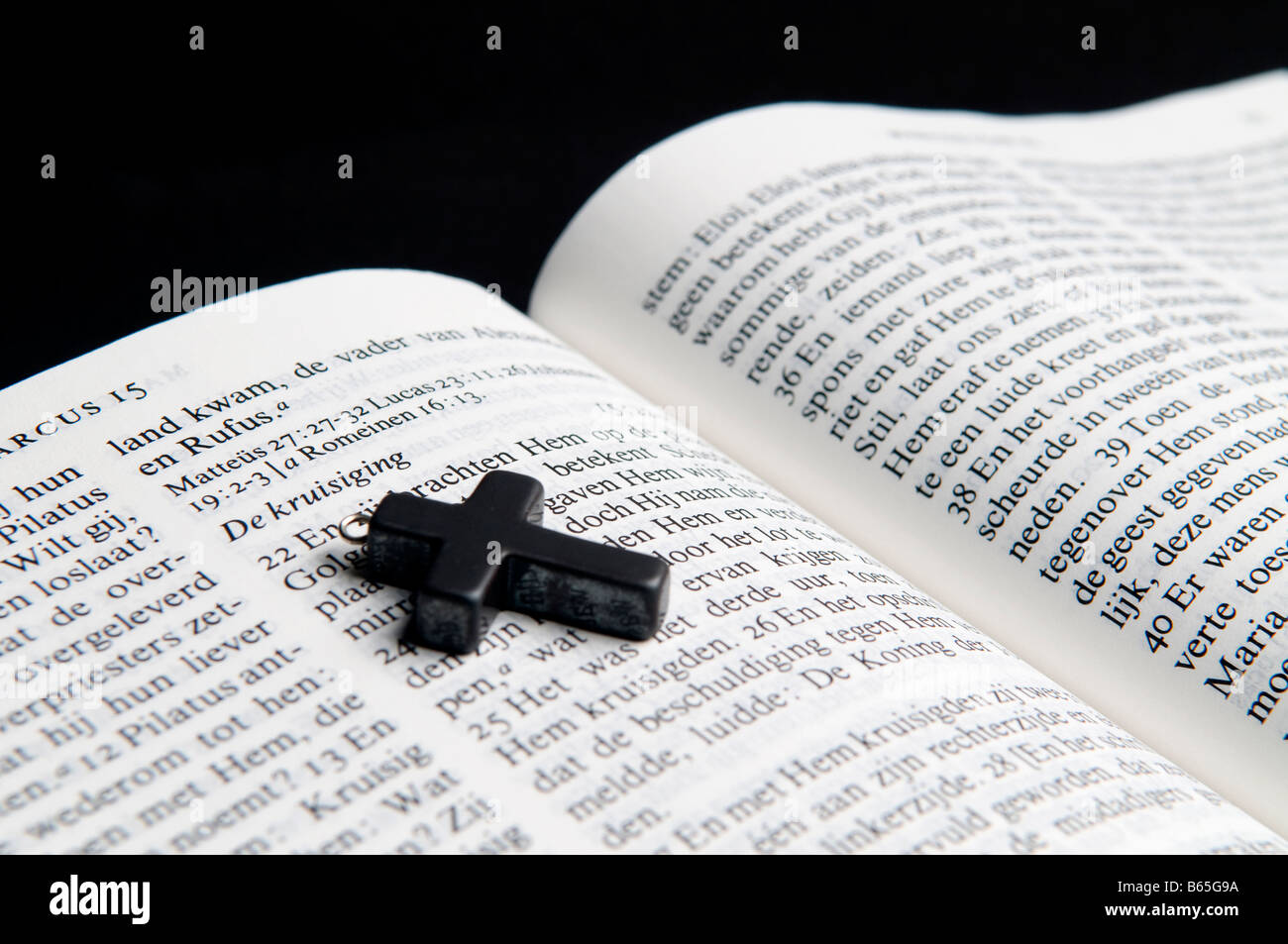 Closeup of Dutch Bible with cross on black background Stock Photo - Alamy