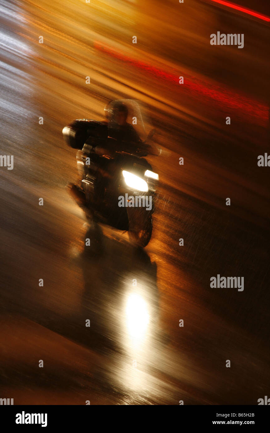 fast motorbike rider heavy rain at night in town Stock Photo - Alamy