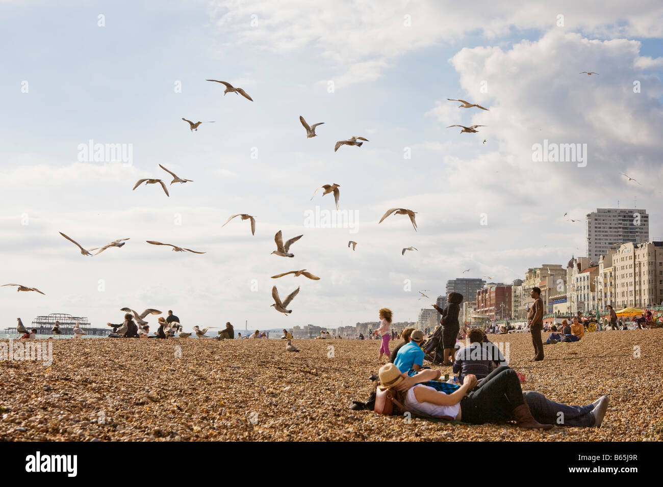 People relaxing on Brighton Beach Stock Photo - Alamy