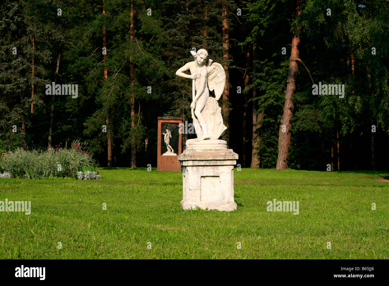 A neoclassical statue of an angel in the gardens of the 18th century ...