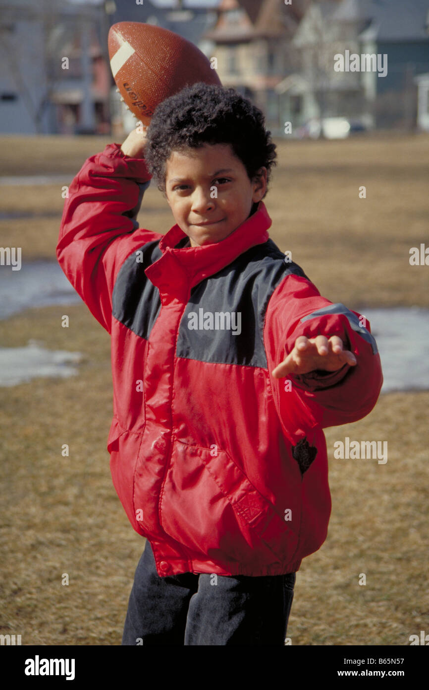 Grade school boy playing football. St. Paul, Minnesota Stock Photo - Alamy