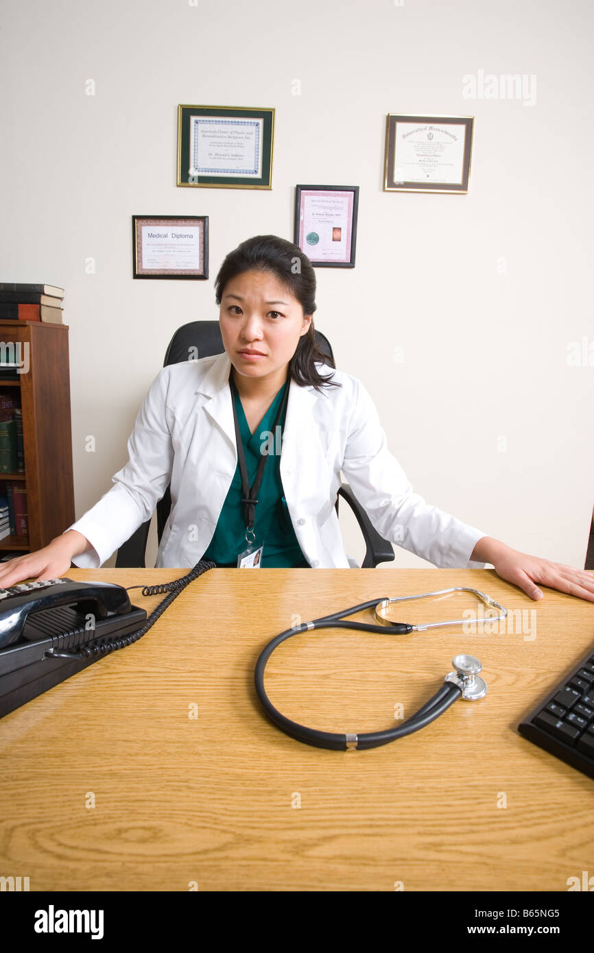 Female doctor at her desk Stock Photo - Alamy