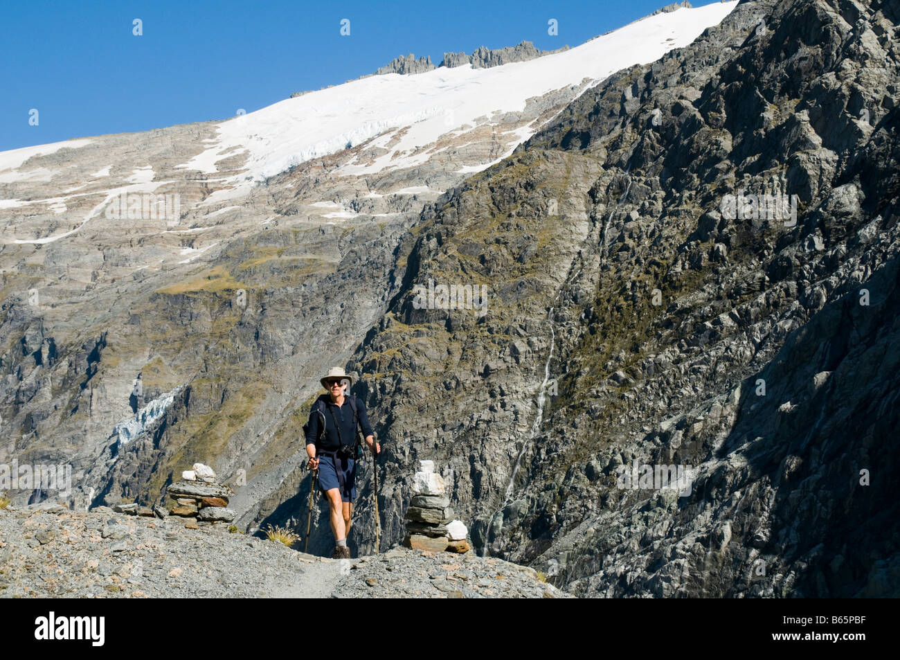 A walker in the upper Dart Valley, Cascade Saddle track, Mount Aspiring ...