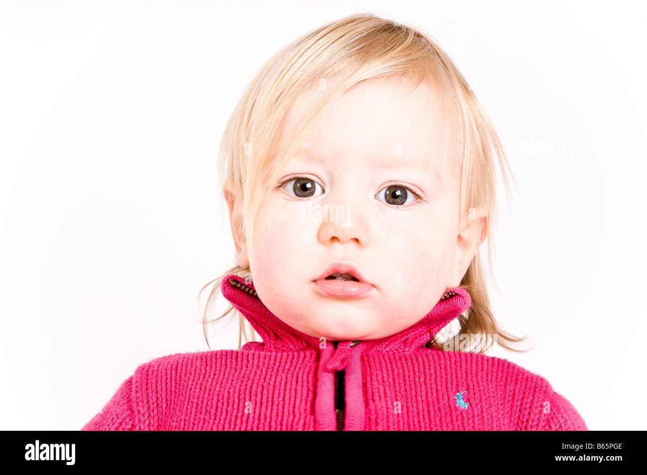 Young Female caucasion child looking at the camera with a white ...