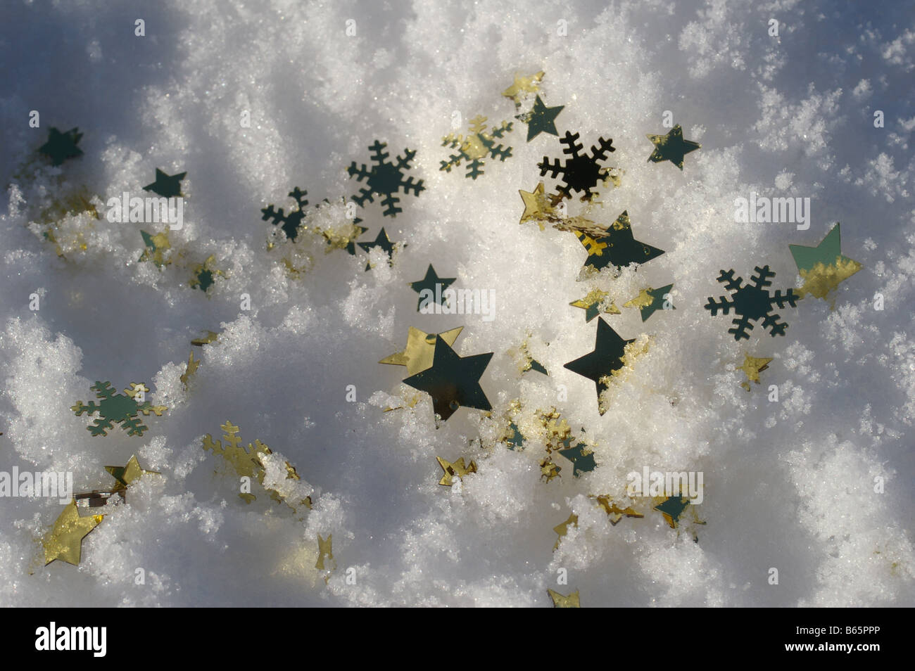 golden snow stars on a real snowy icy surface Stock Photo - Alamy