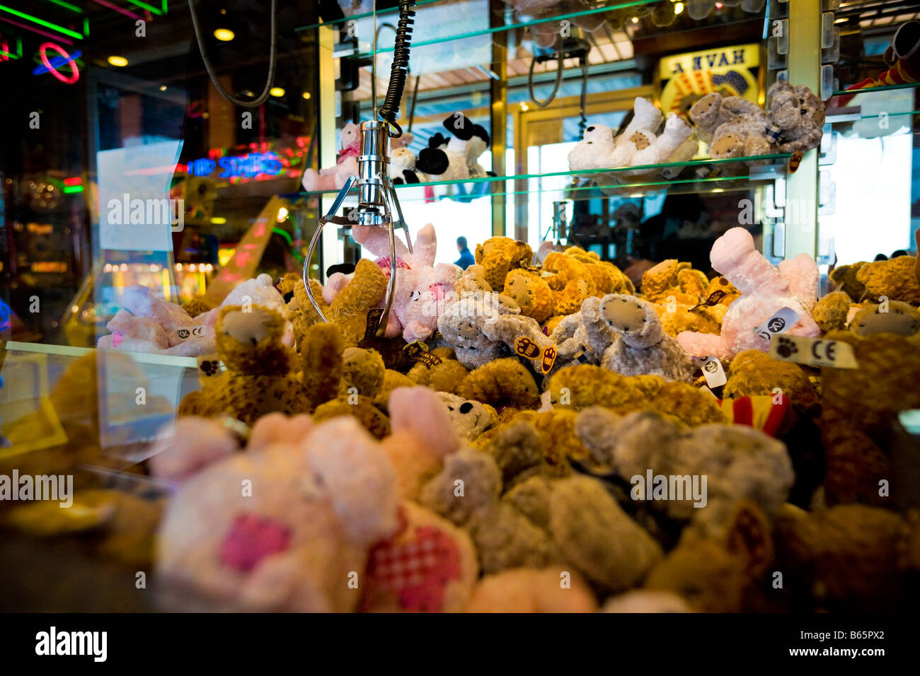 Amusement arcade game with crane grabbing a cuddly toy UK Stock Photo ...