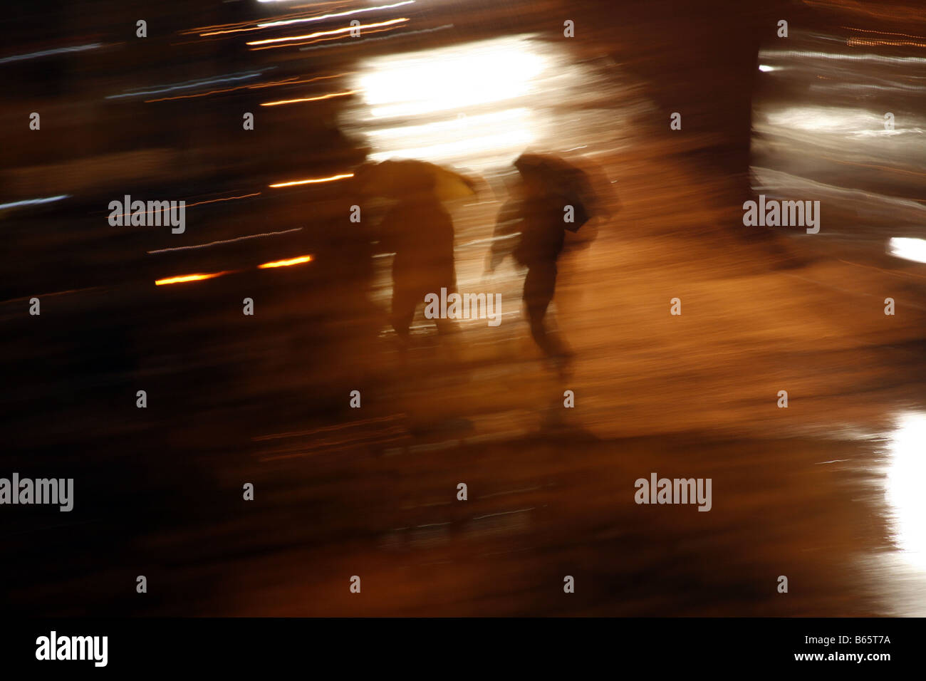 people walking in heavy rain at night in town Stock Photo - Alamy